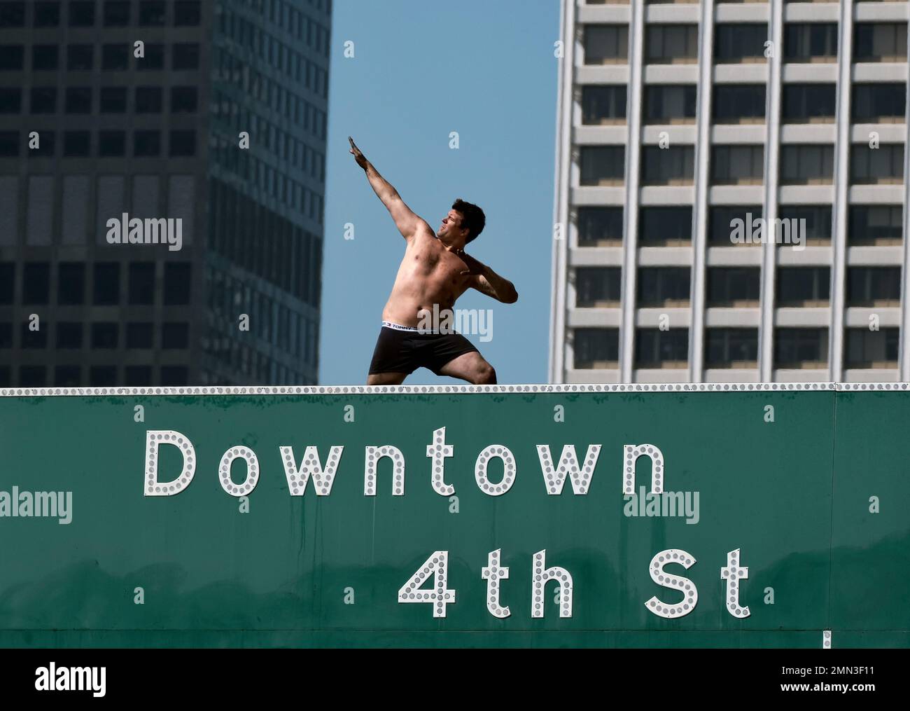 An activist poses atop a freeway sign while California Highway Patrol ...