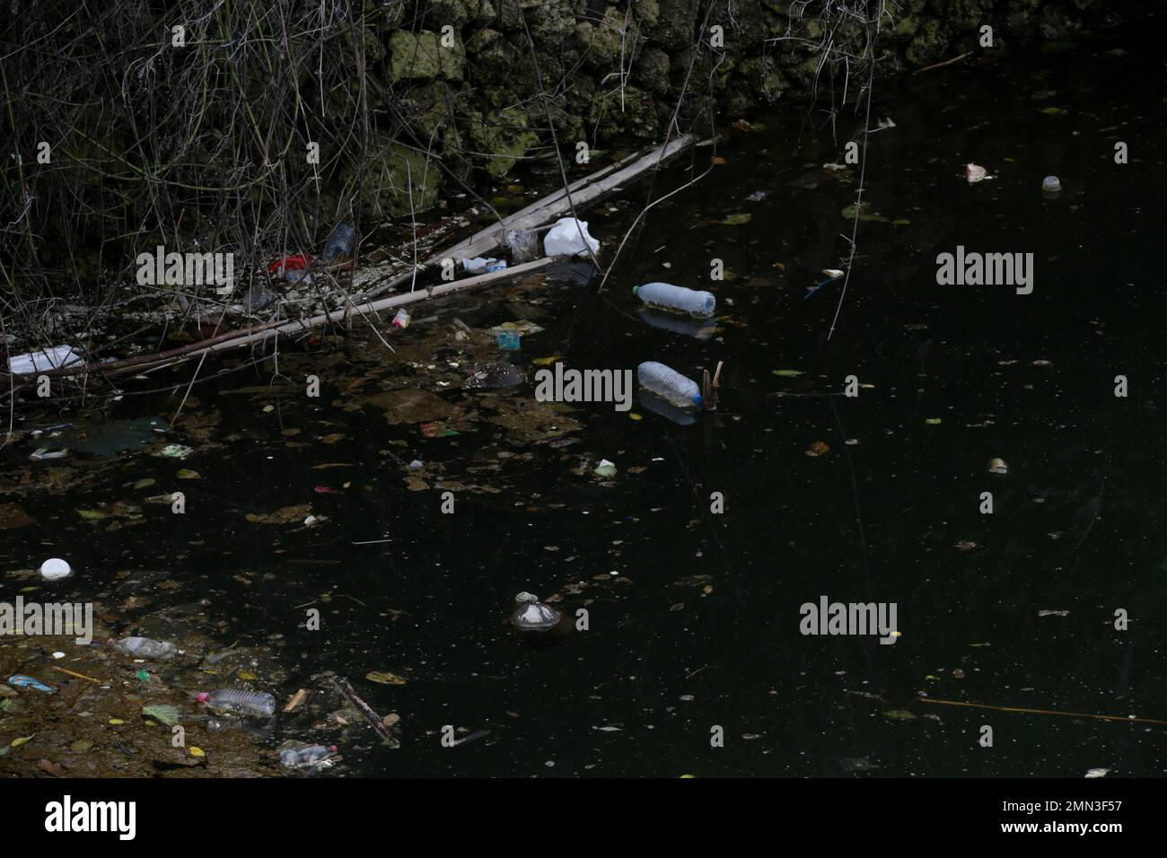 A giant floating rubbish heap floating in the river, plastic pollution ...