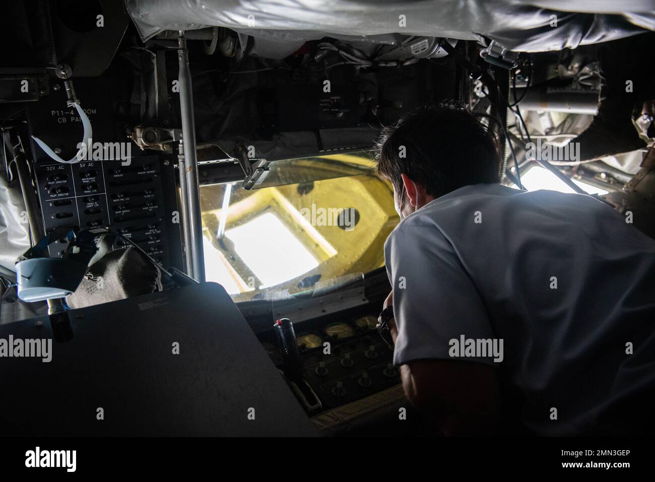 A Japanese Air Self Defense Force cadet looks out the boom operator’s window in a KC-135 ...
