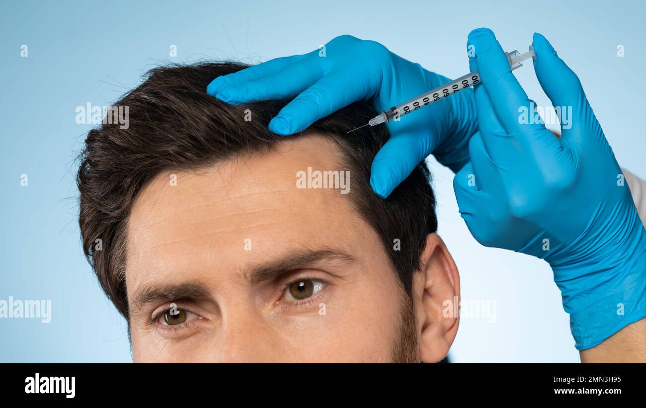 Handsome man receiving injections in his head, having mesotherapy ...
