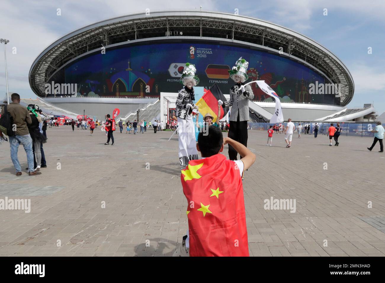 A Chinese soccer fan wearing his national flag takes photo prior to the ...