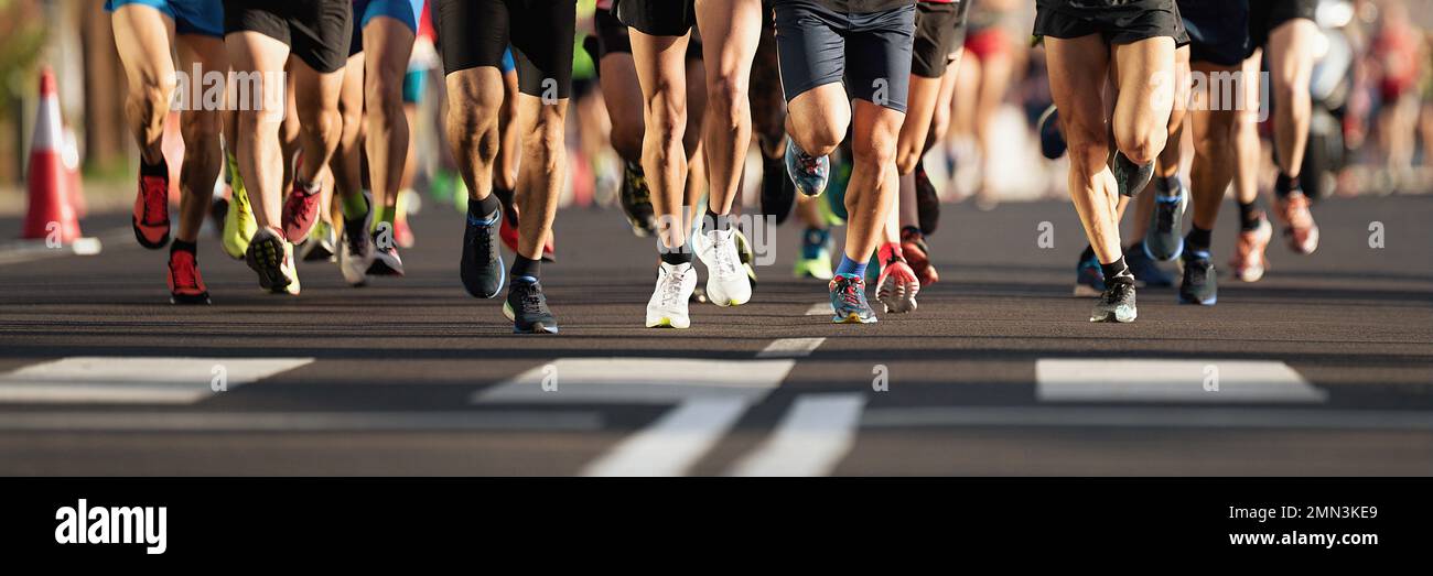 Marathon runners running on city road, large group of runners Stock ...