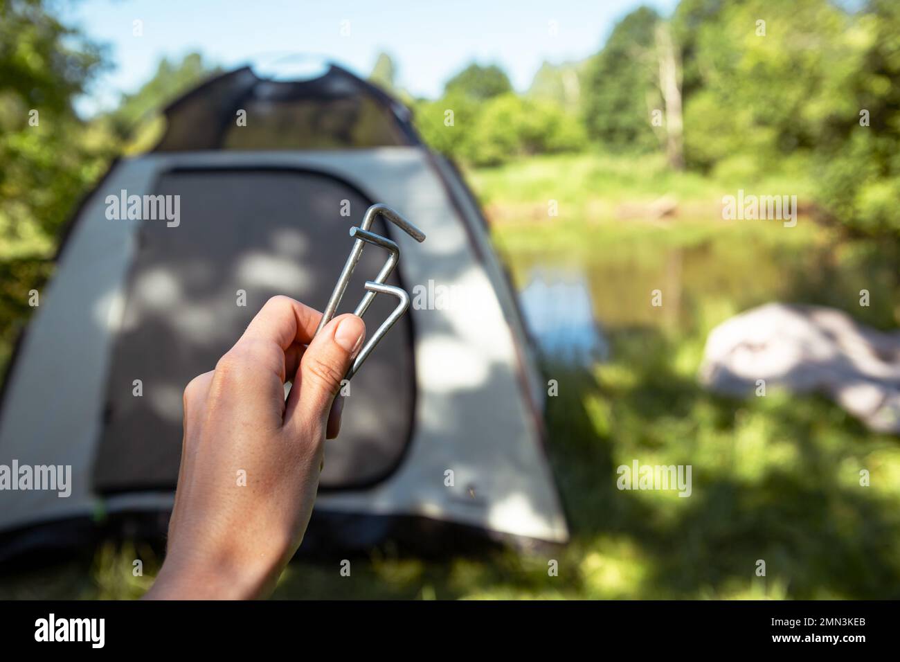 Aluminum stakes for the installation of a tourist tent in the hand ...