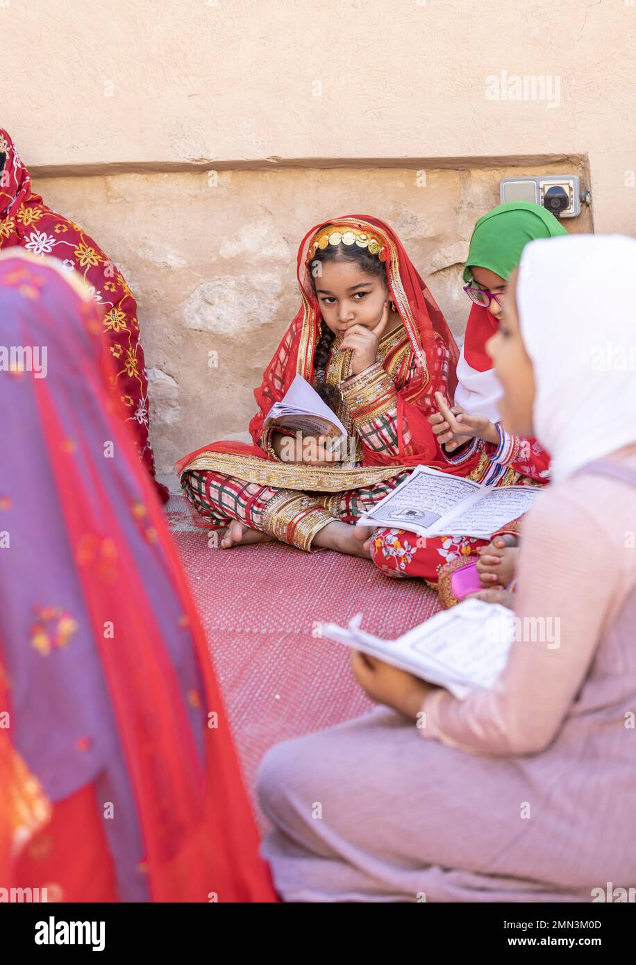 Nizwa, Oman, 2nd December 2022: omani girls reciting a Holy Book Stock ...