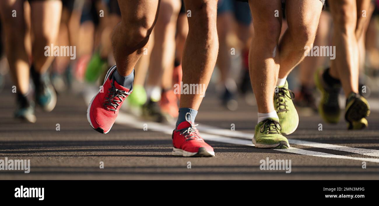 Marathon runners running on city road, large group of runners Stock ...