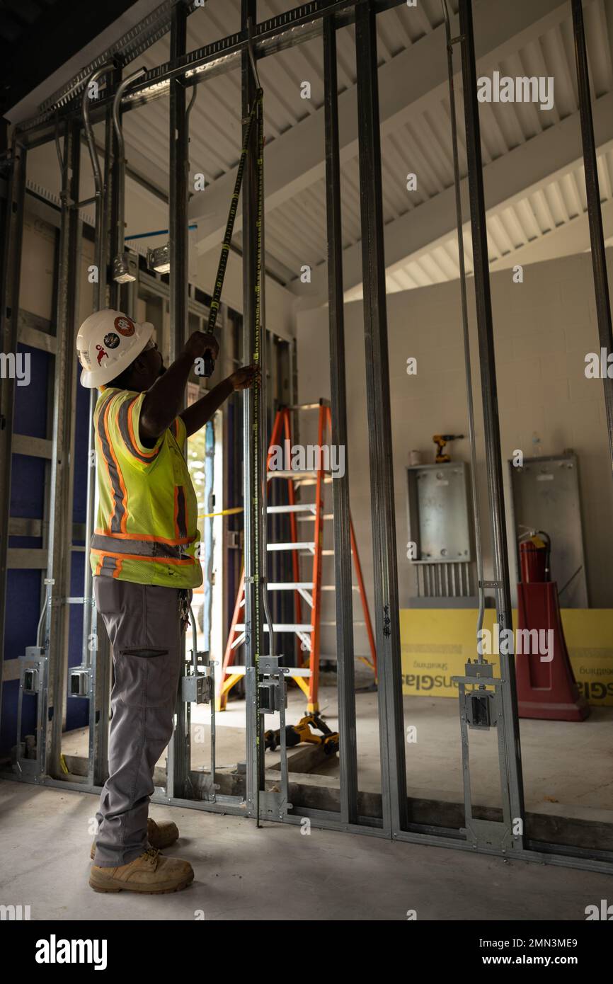Ricardo Henry, a superintendent with LJ Electrical, works at the site ...