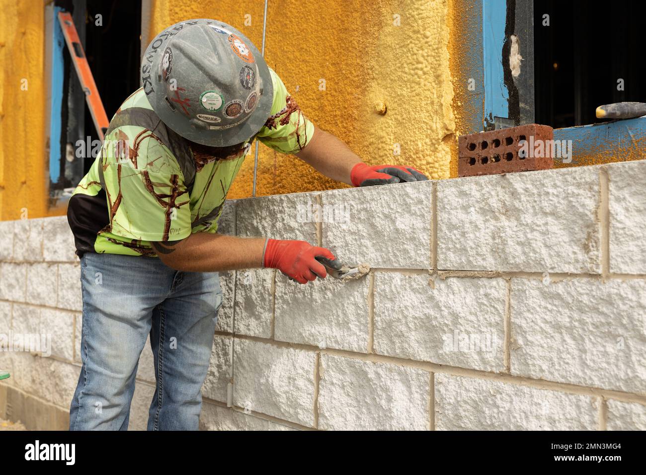 Mark Tyrakowski, a mason with Rush Masonry Management LLC, conducts ...