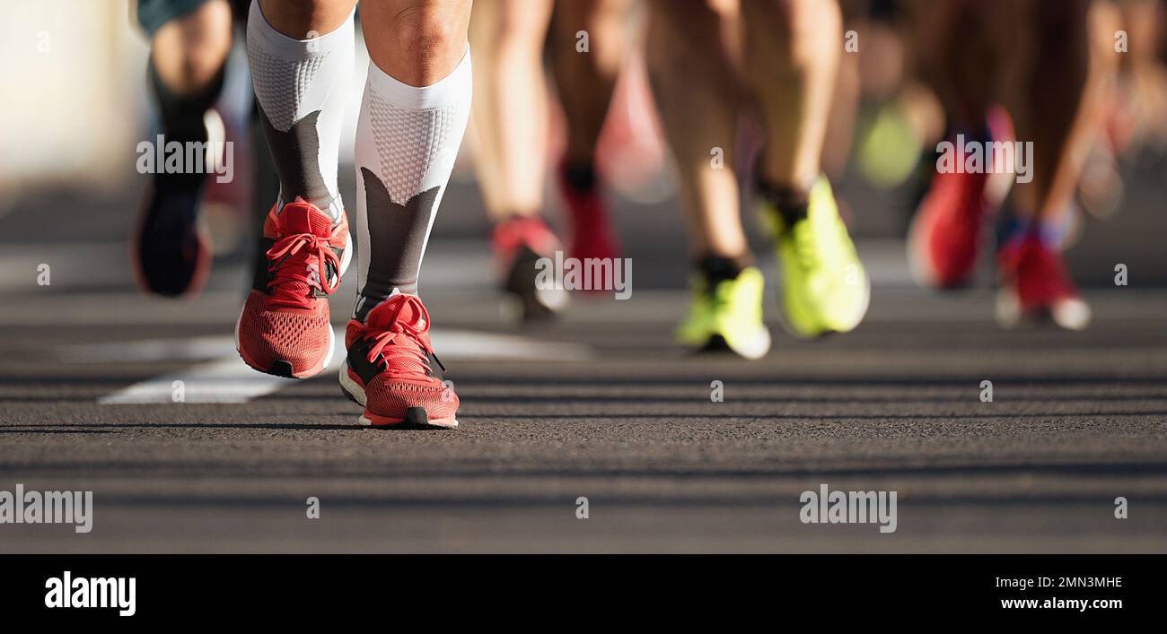 Marathon runners running on city road, large group of runners Stock ...