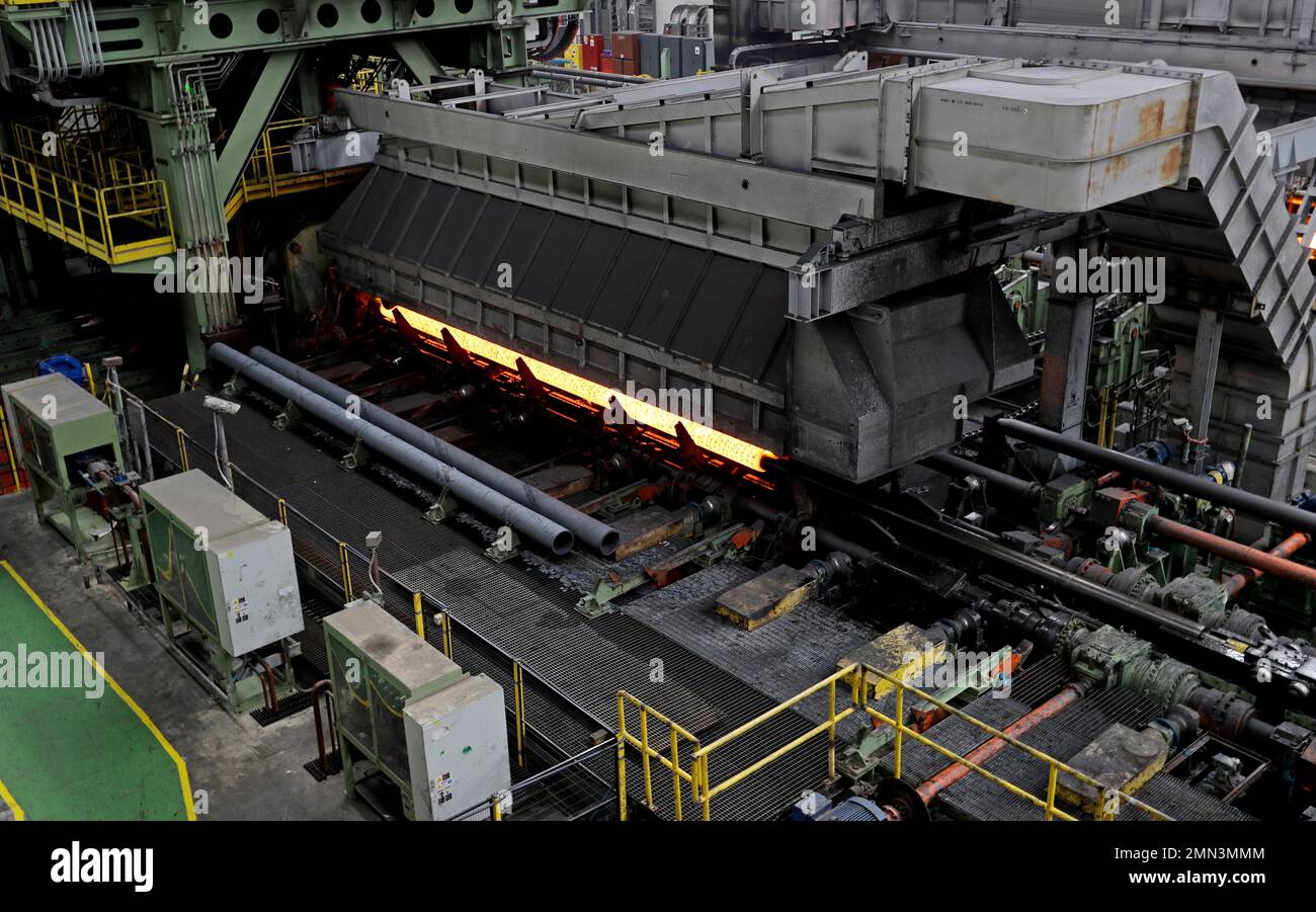 A steel billet is pierced during the hot rolling process to create a ...