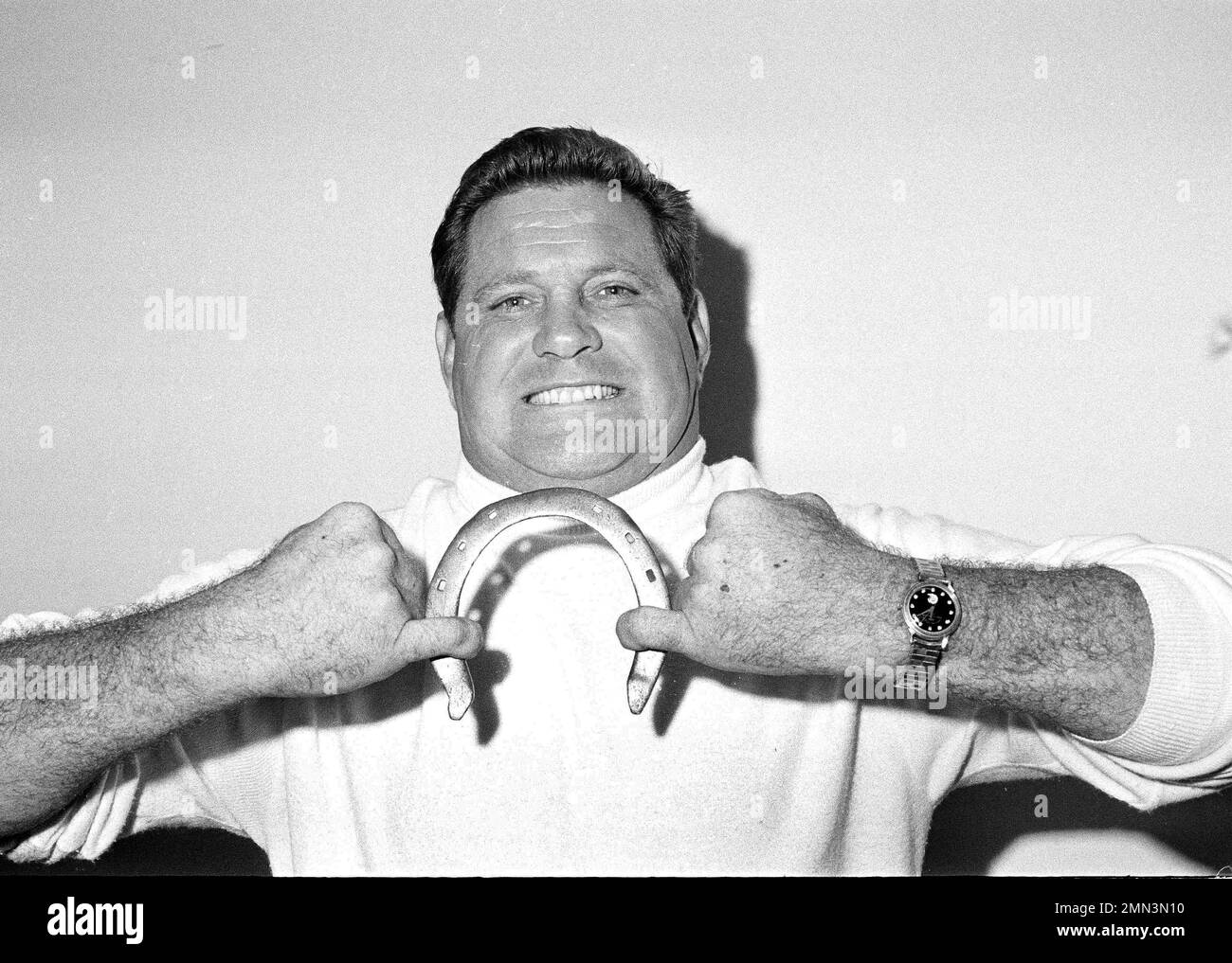 Jim Ringo, center for the Philadelphia Eagles poses with a horseshoe as ...