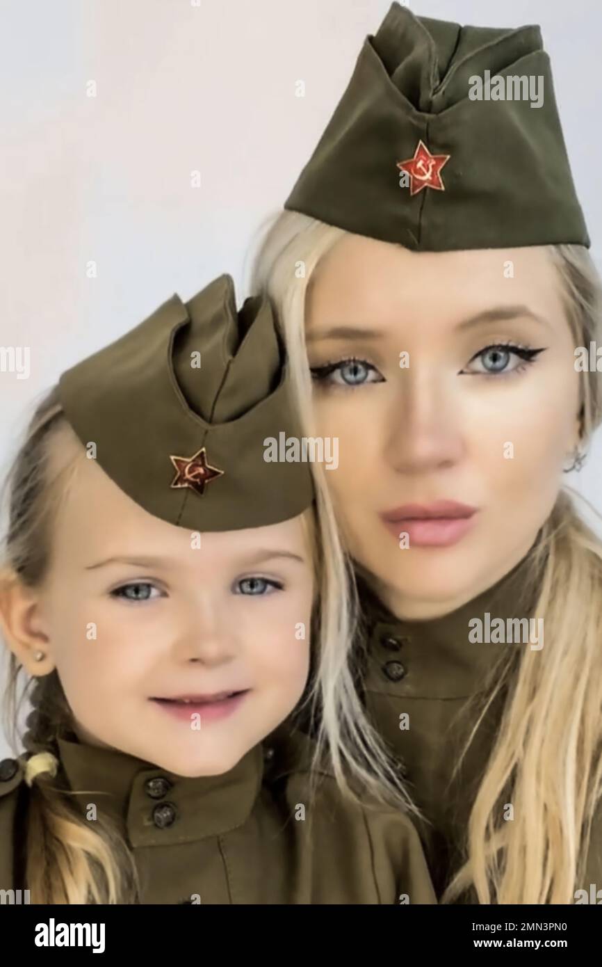 Russian female soldier poses for a portrait with her daughter Stock ...