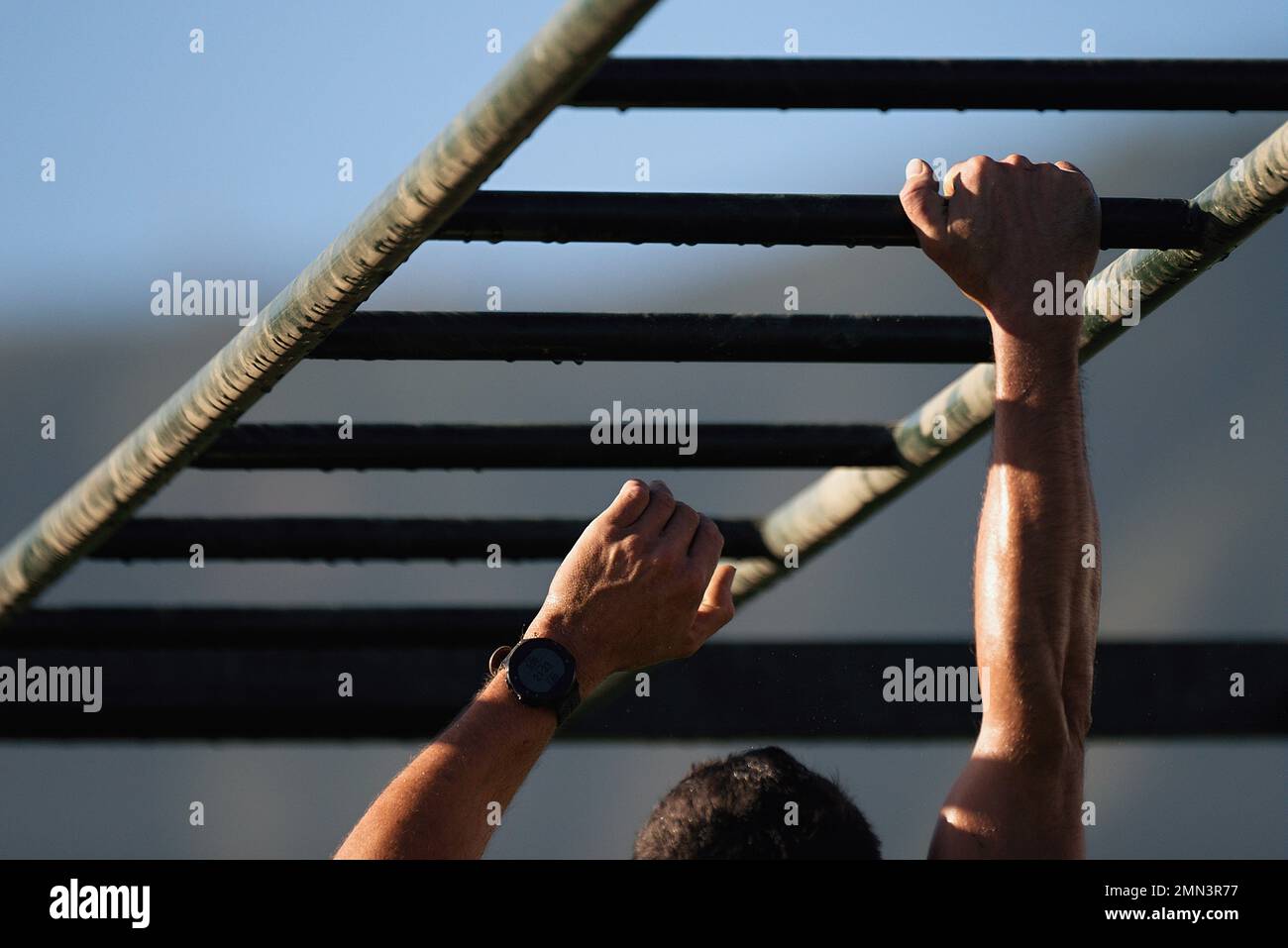 Mud race running over obstacles race runners,hands overcome obstacle ...