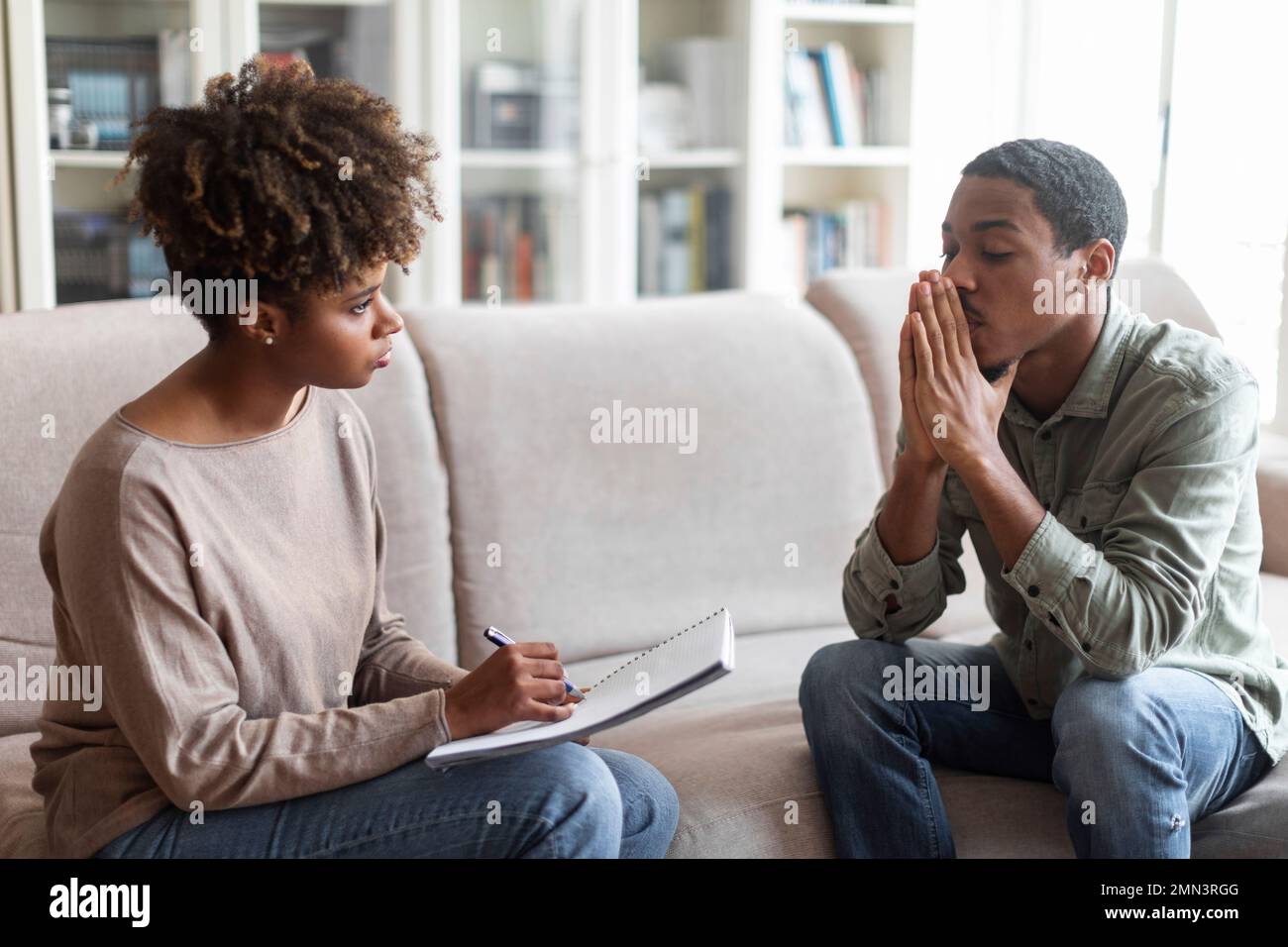 Black man fighting addiction, visiting psychologist alone Stock Photo ...