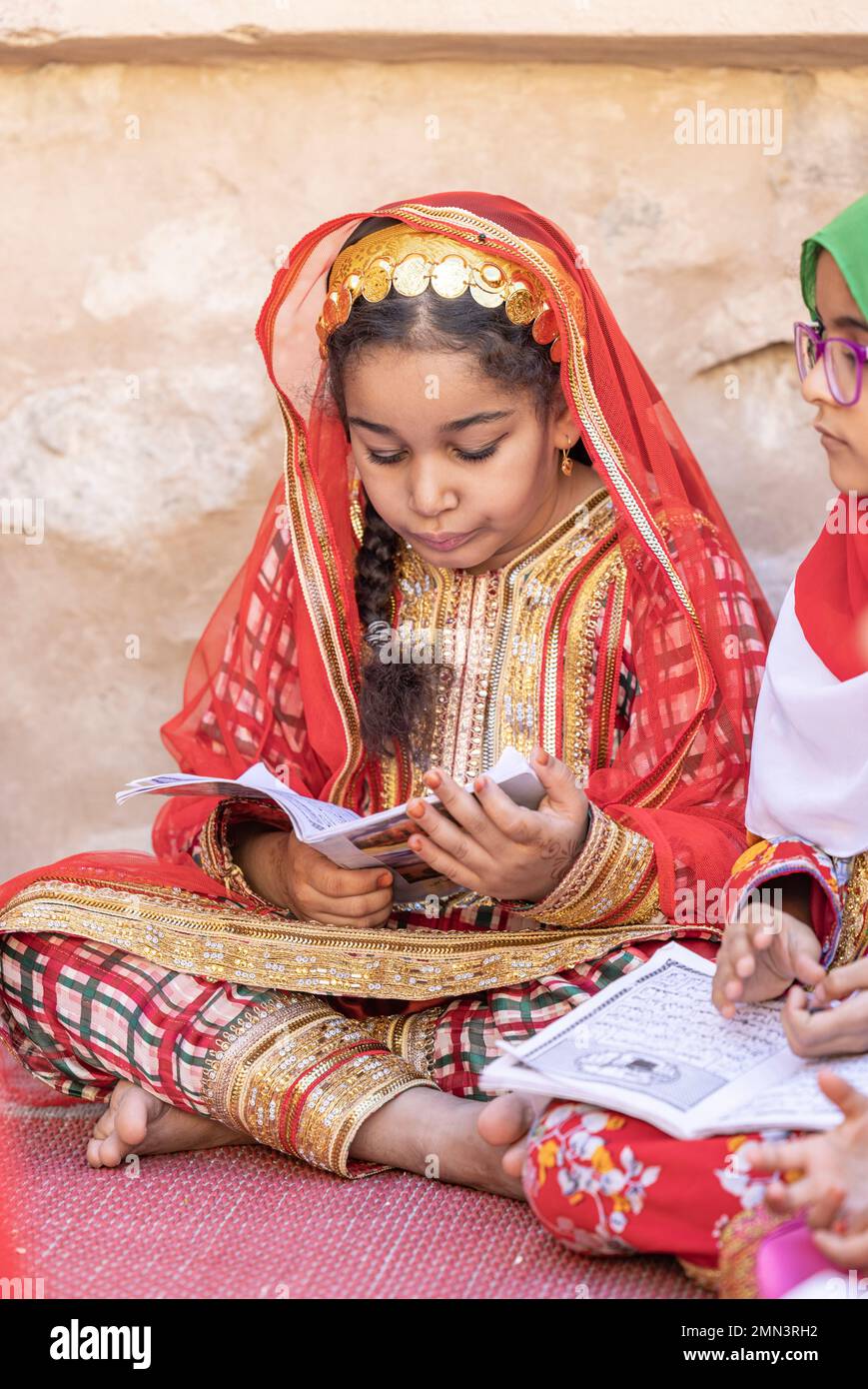 Nizwa, Oman, 2nd December 2022: omani girls reciting a Holy Book Stock ...
