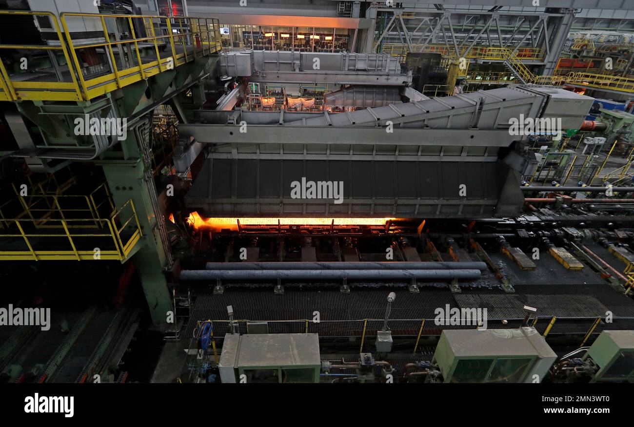 A steel billet is pierced during the hot rolling process to create a ...