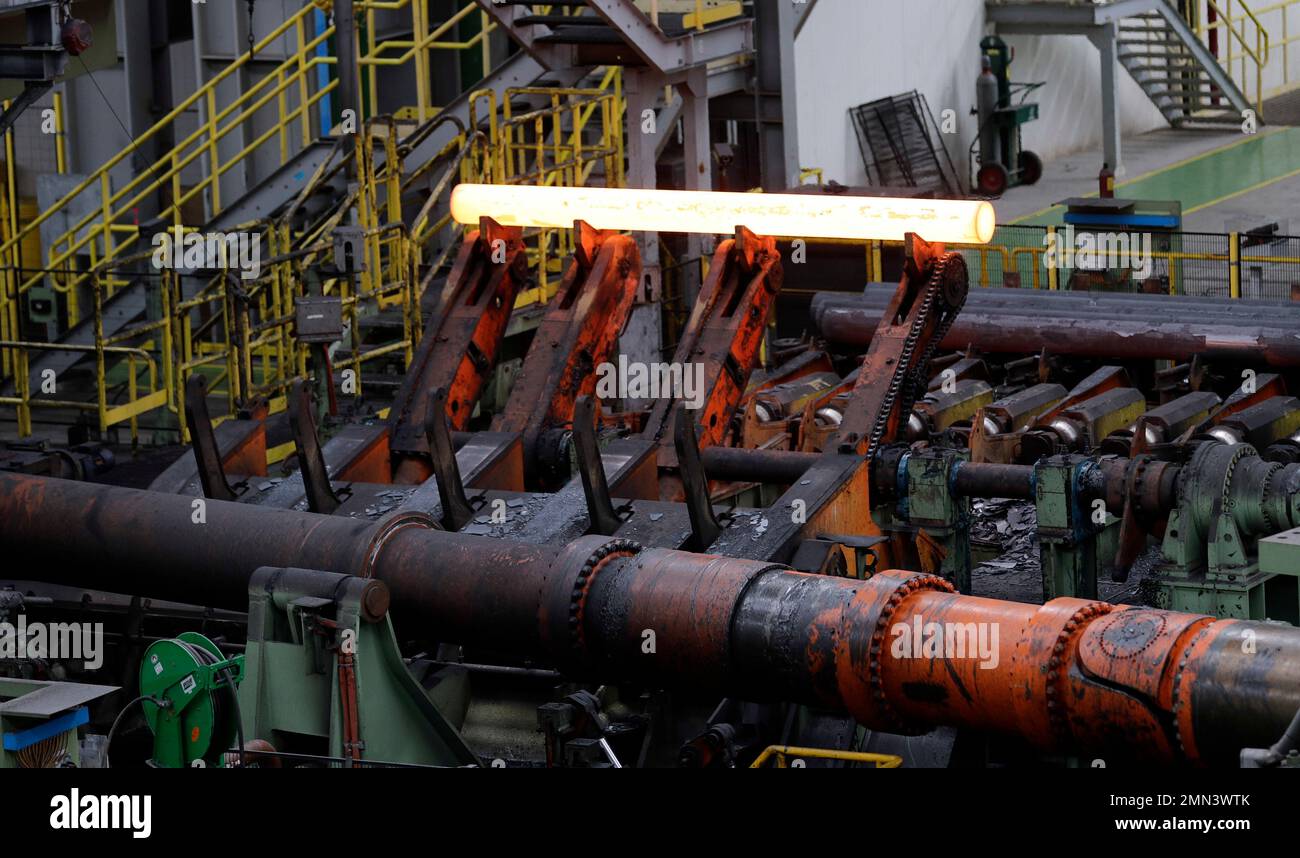 A steel billet goes through the hot rolling process to create a ...