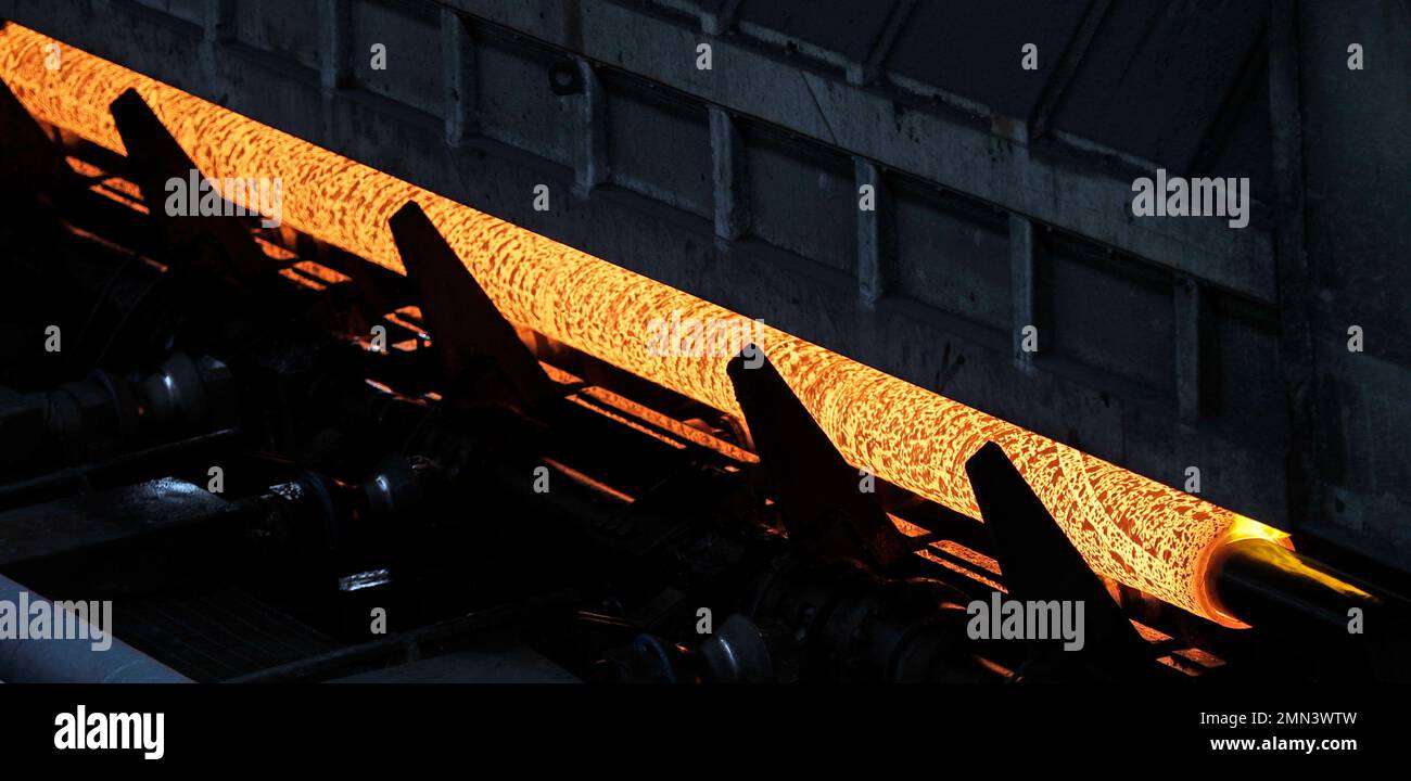 A steel billet is pierced during the hot rolling process to create a ...