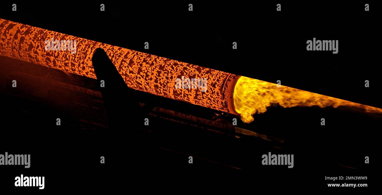 A steel billet is pierced during the hot rolling process to create a ...
