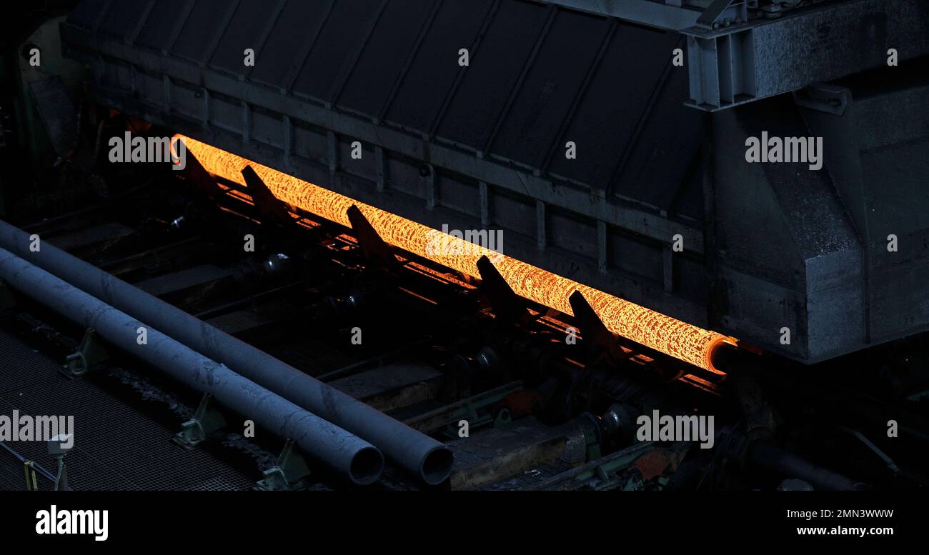 A steel billet is pierced during the hot rolling process to create a ...