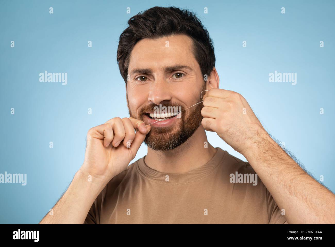 Happy middle aged man using dental thread floss and smiling, cleaning ...