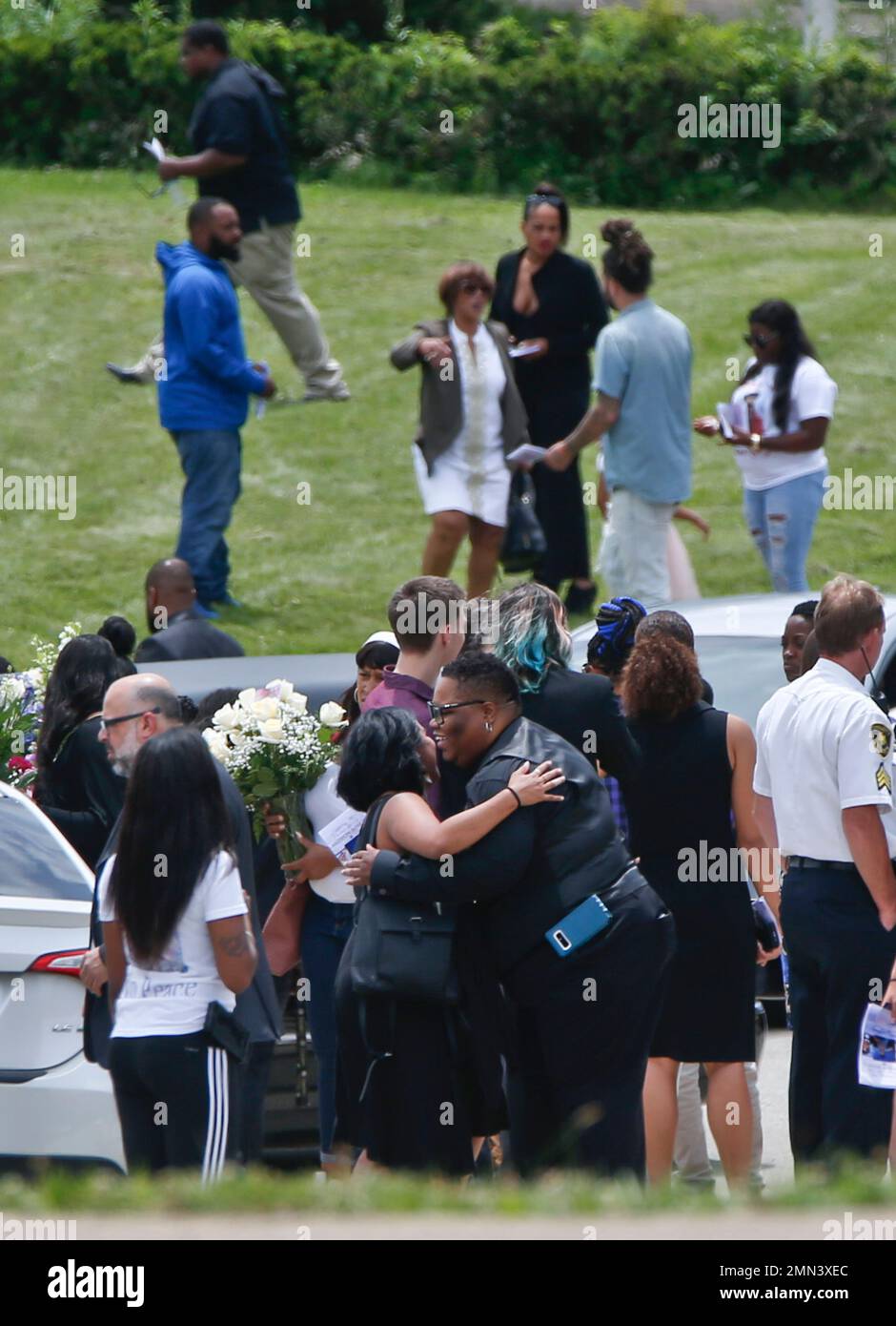Mourners gather and embrace as they leave the funeral for Antwon Rose ...