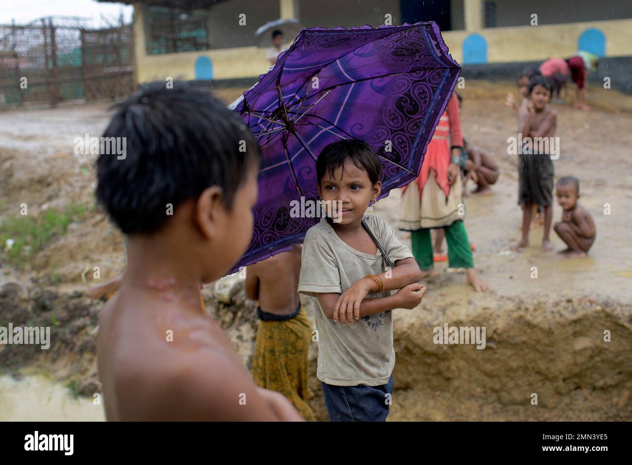 Rohingya children play in the rain in Kutupalong Rohingya refugee camp ...