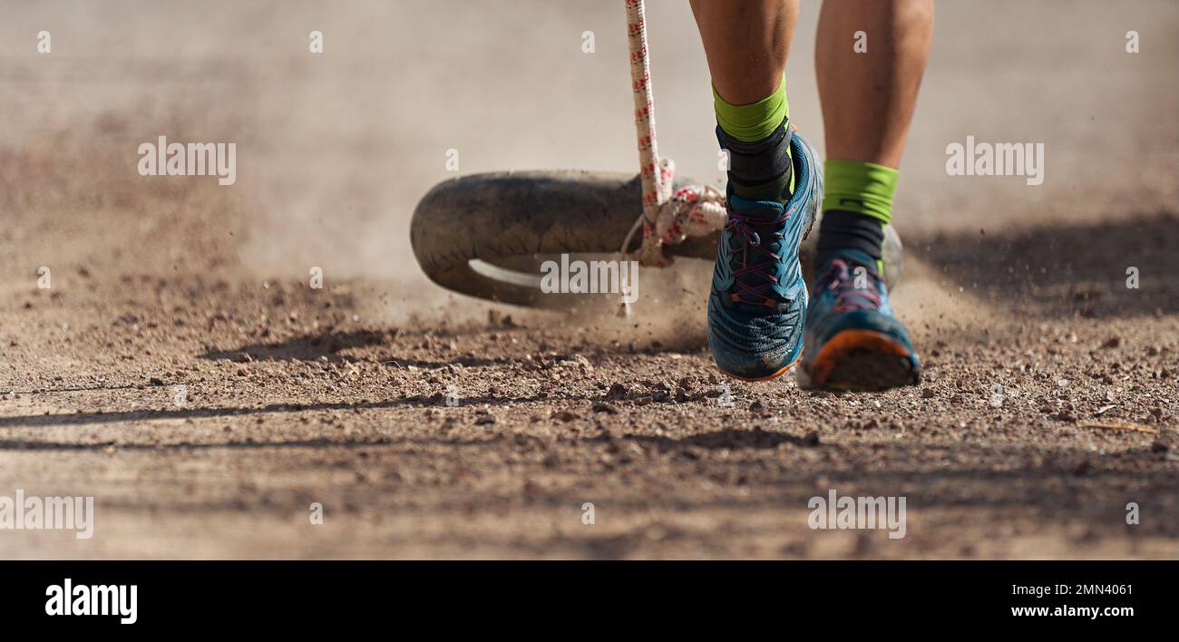 Athlete pulling car tires at a training run Stock Photo - Alamy
