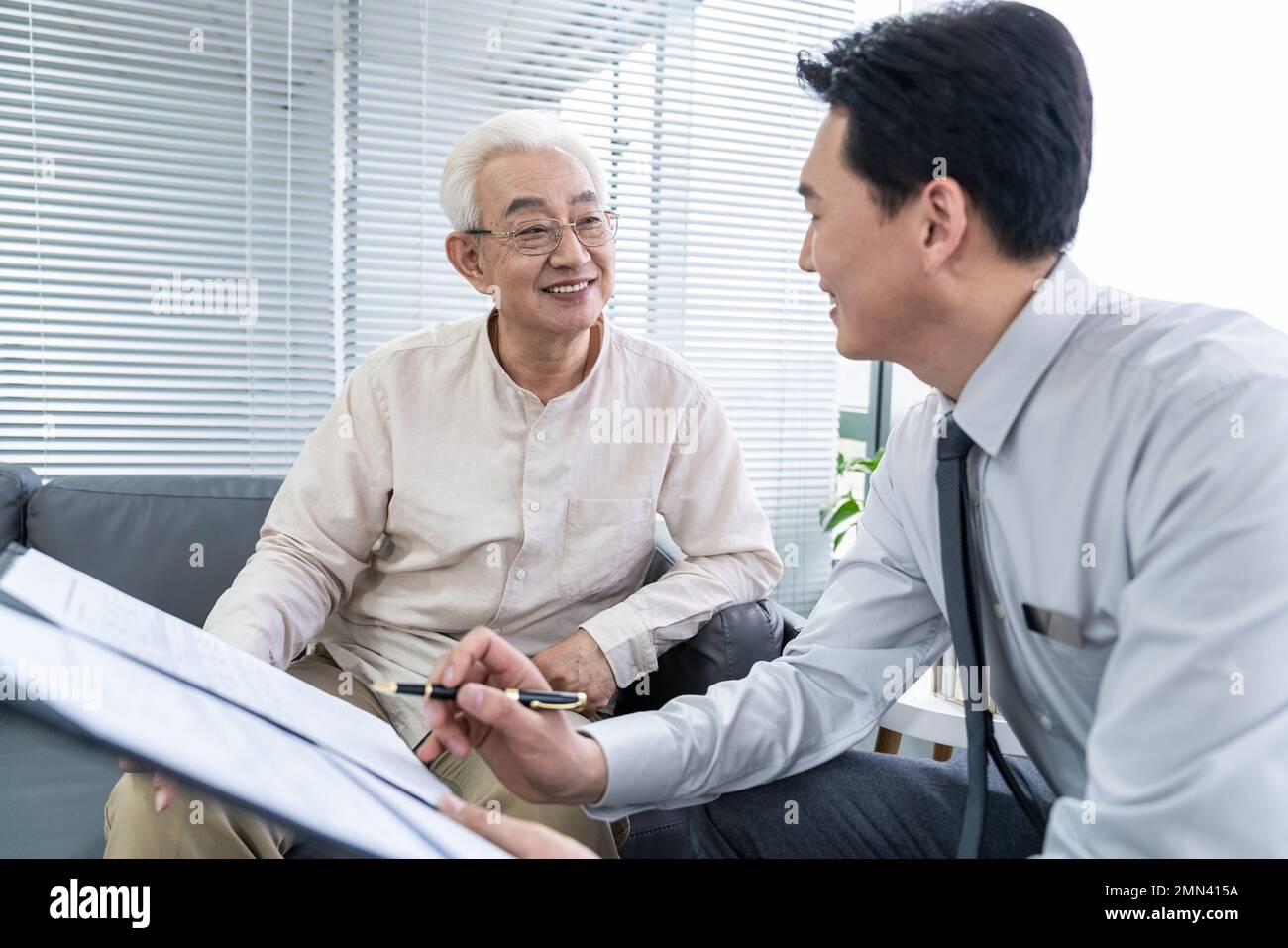 Older men with a financial adviser Stock Photo - Alamy