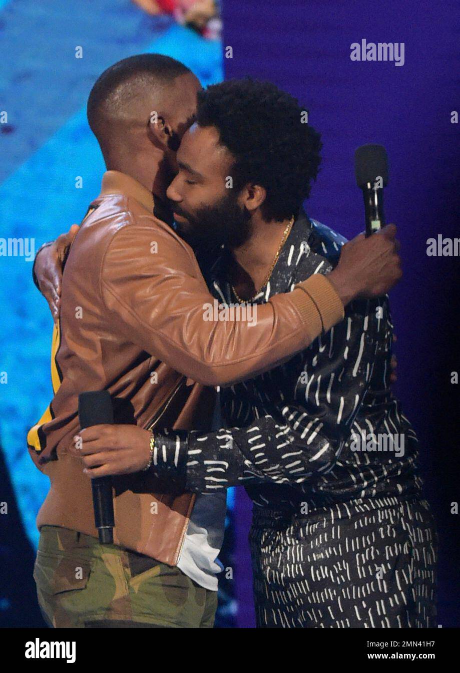 Host Jamie Foxx, left, and Donald Glover hug on stage at the BET Awards ...