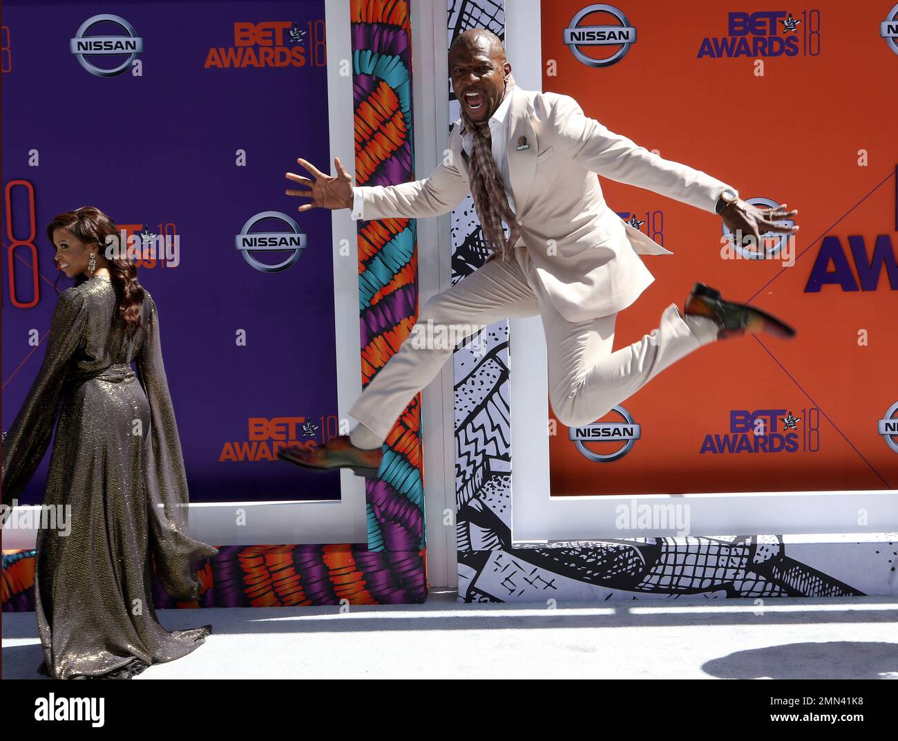 Terry Crews jumps as he arrives at the BET Awards at the Microsoft ...