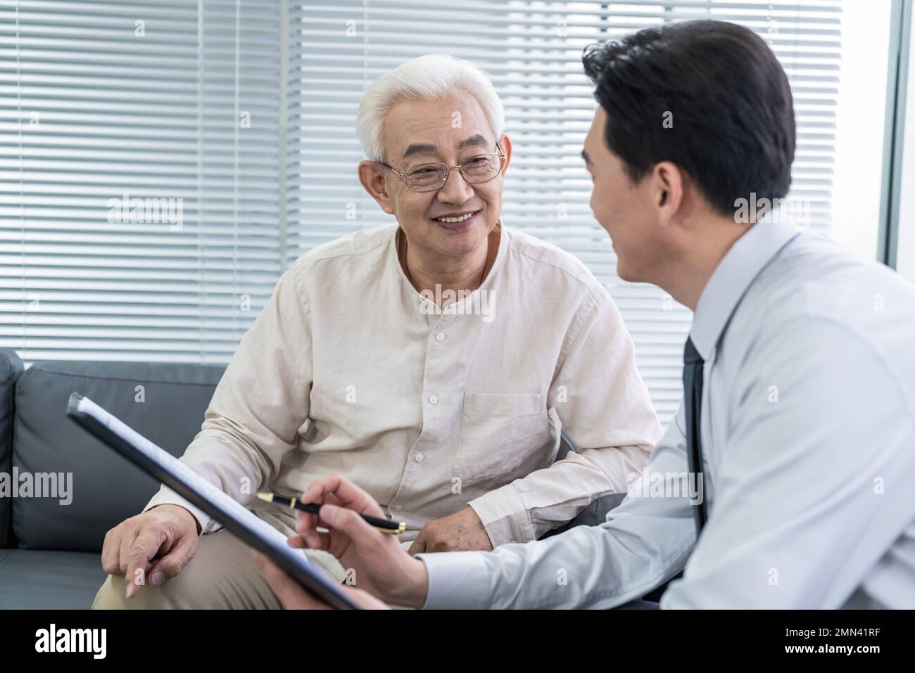Older men with a financial adviser Stock Photo - Alamy
