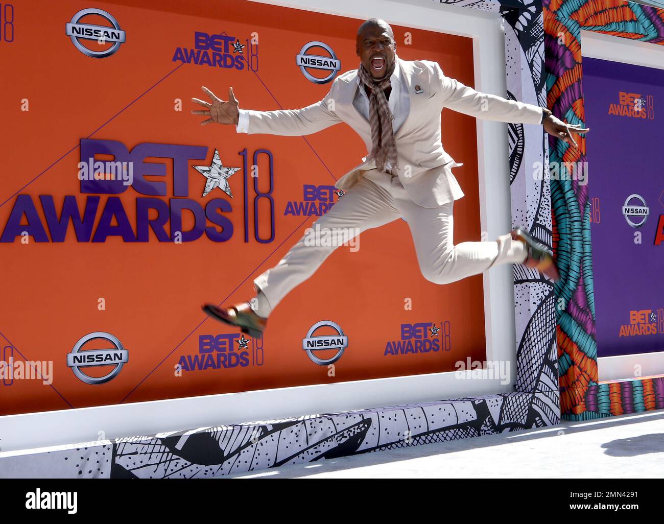 Terry Crews jumps as he arrives at the BET Awards at the Microsoft ...