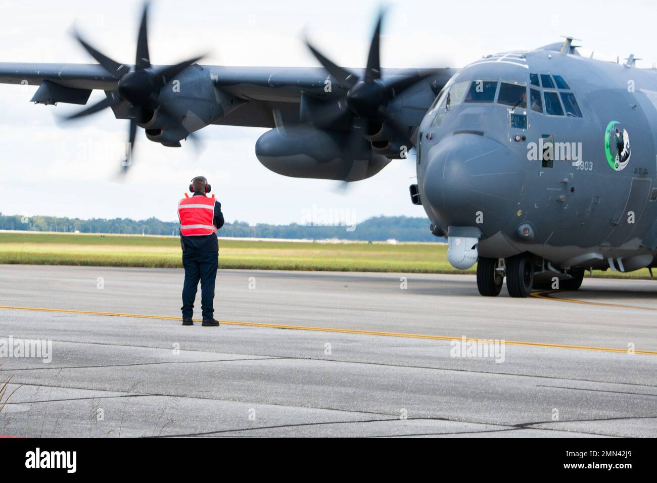 A contractor with the 88th Operations Support Squadron guides an AC ...