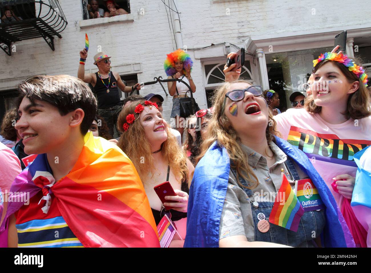 Spectators react as they watch the Gay Pride Parade Sunday June 24 ...