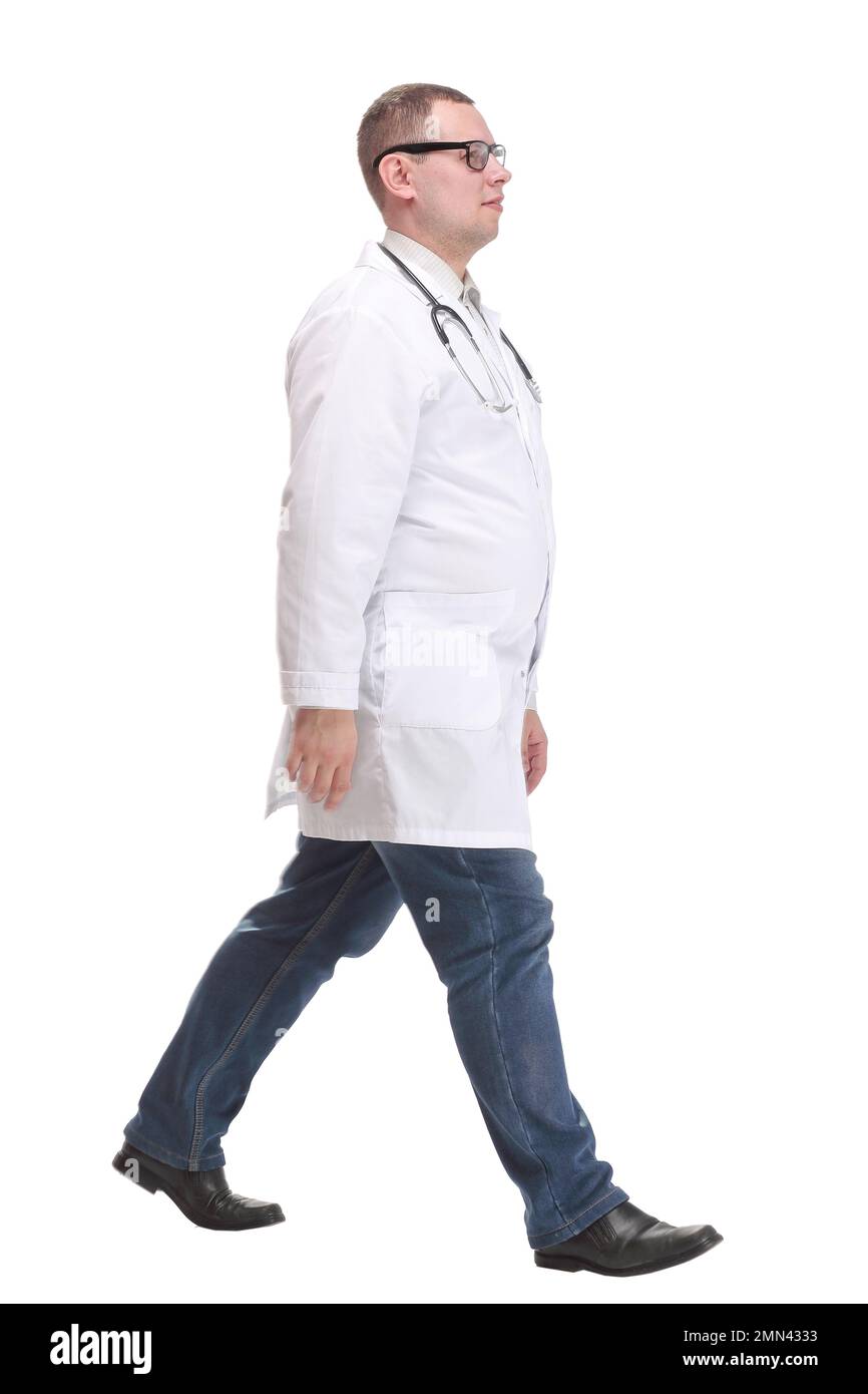 Male doctor walking isolated over a white background looking at camera ...