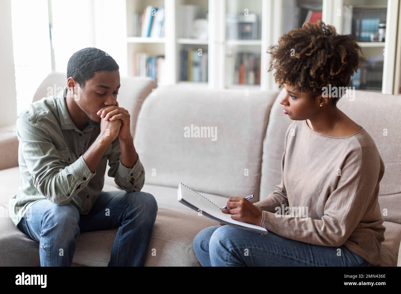 Black woman psychologist have conversation with frustrated young man ...