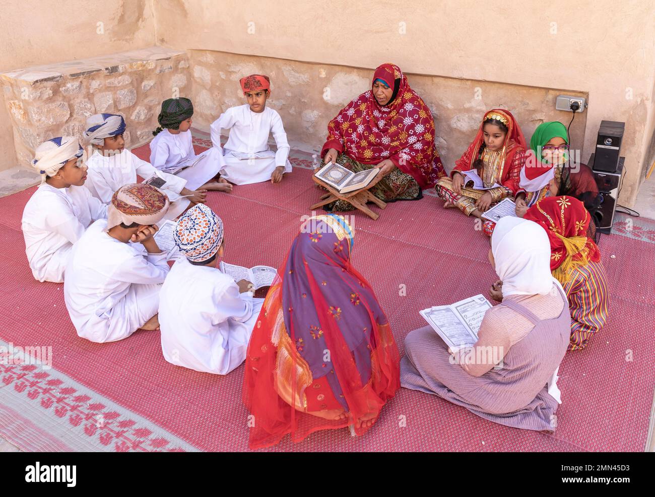 Nizwa, Oman, 2nd December 2022: omani kids reciting a Holy Book Stock ...