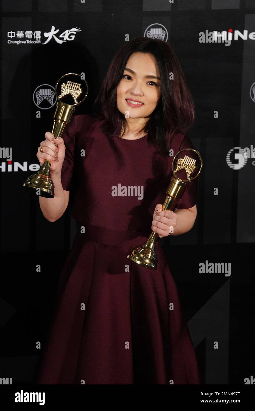 Taiwanese singer Lala Hsu holds her awards for the Best Female Mandarin Singer and Best Album in ...