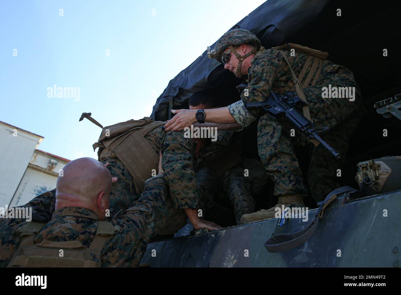 U.S. Marines with 3rd Marine Logistics Group load their gear onto a ...
