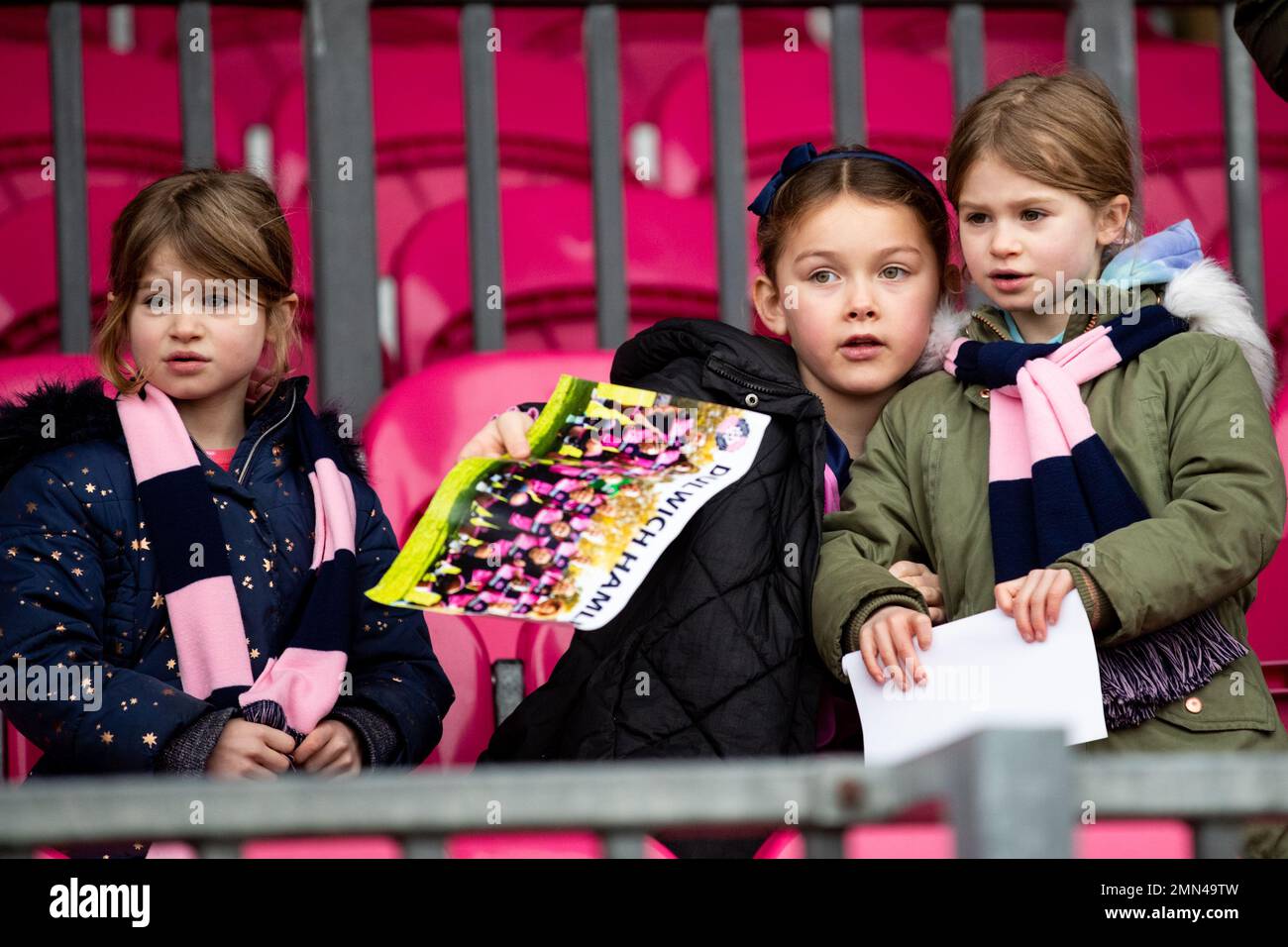 Young girls, fans of Dulwich Hamlet FC Women, watching the players warm ...