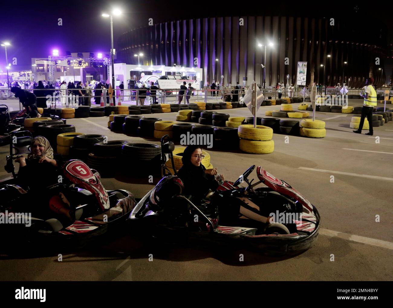 In this June 22, 2018 photo, women ride go carts at a road safety event ...