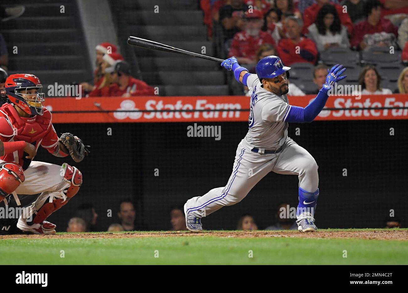 Toronto Blue Jays' Devon Travis, right, hits an Rbi double as Los ...