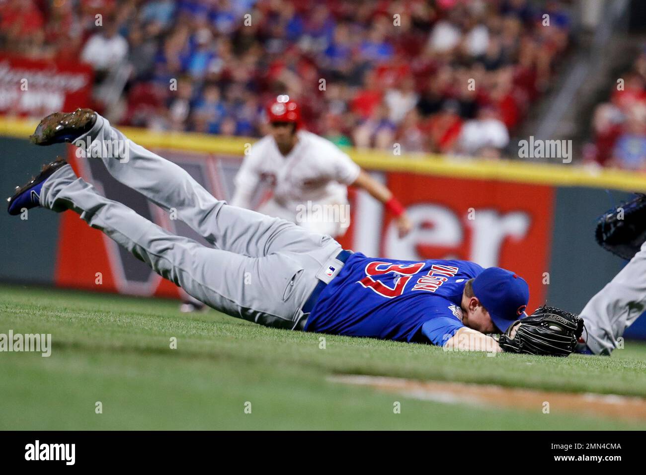 Chicago Cubs relief pitcher Justin Wilson catches a pop bunt by ...