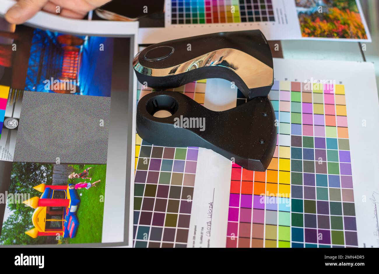 Technician uses a spectrocolorimeter to read patches with various ...