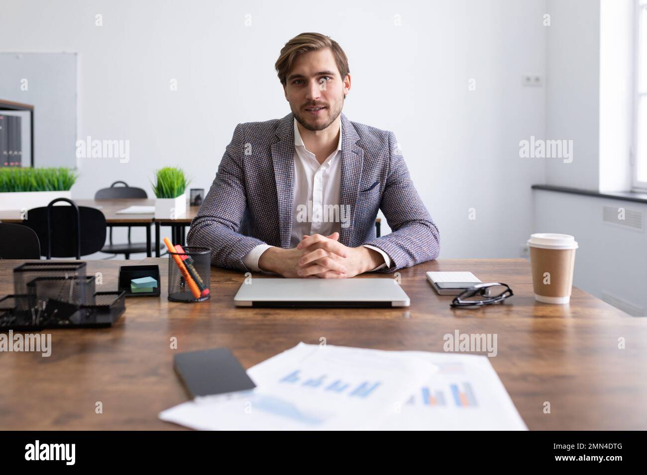 successful business man conducts an interview while sitting at a table ...