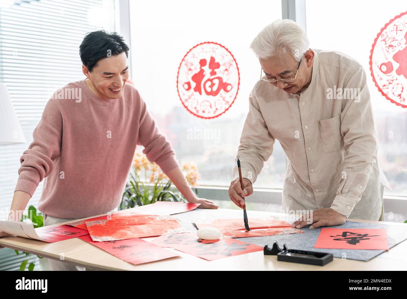 Happy father and son at home to write calligraphy Stock Photo - Alamy