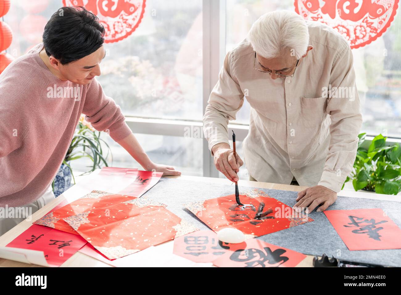 Happy father and son at home to write calligraphy Stock Photo - Alamy
