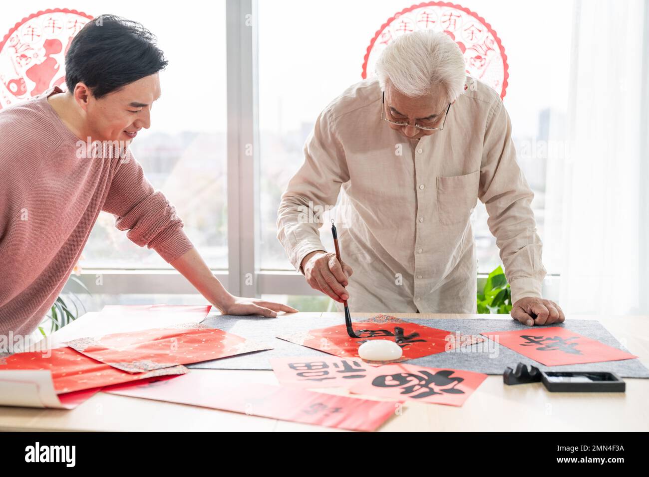 Happy father and son at home to write calligraphy Stock Photo - Alamy