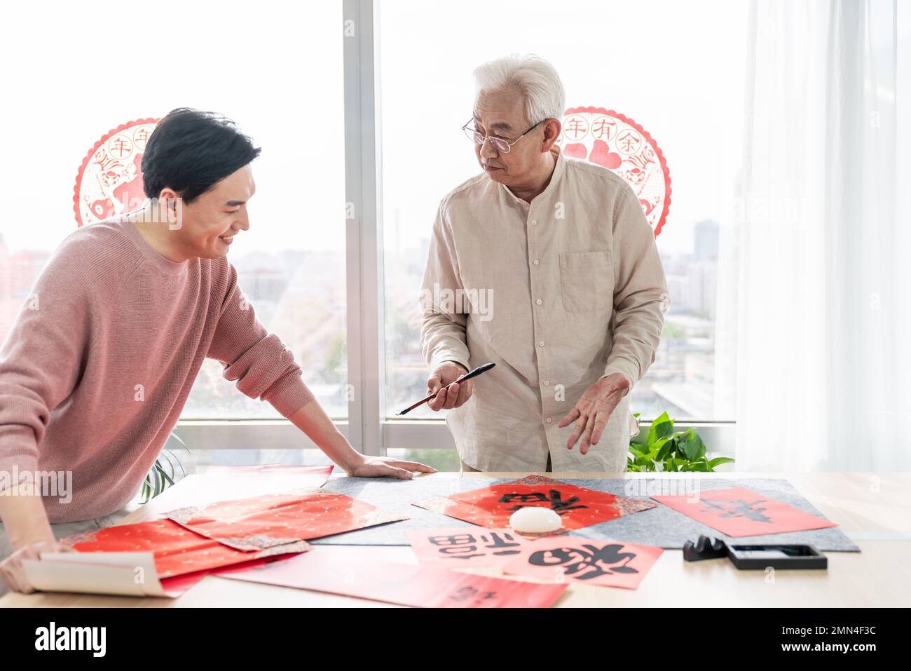 Happy father and son at home to write calligraphy Stock Photo - Alamy