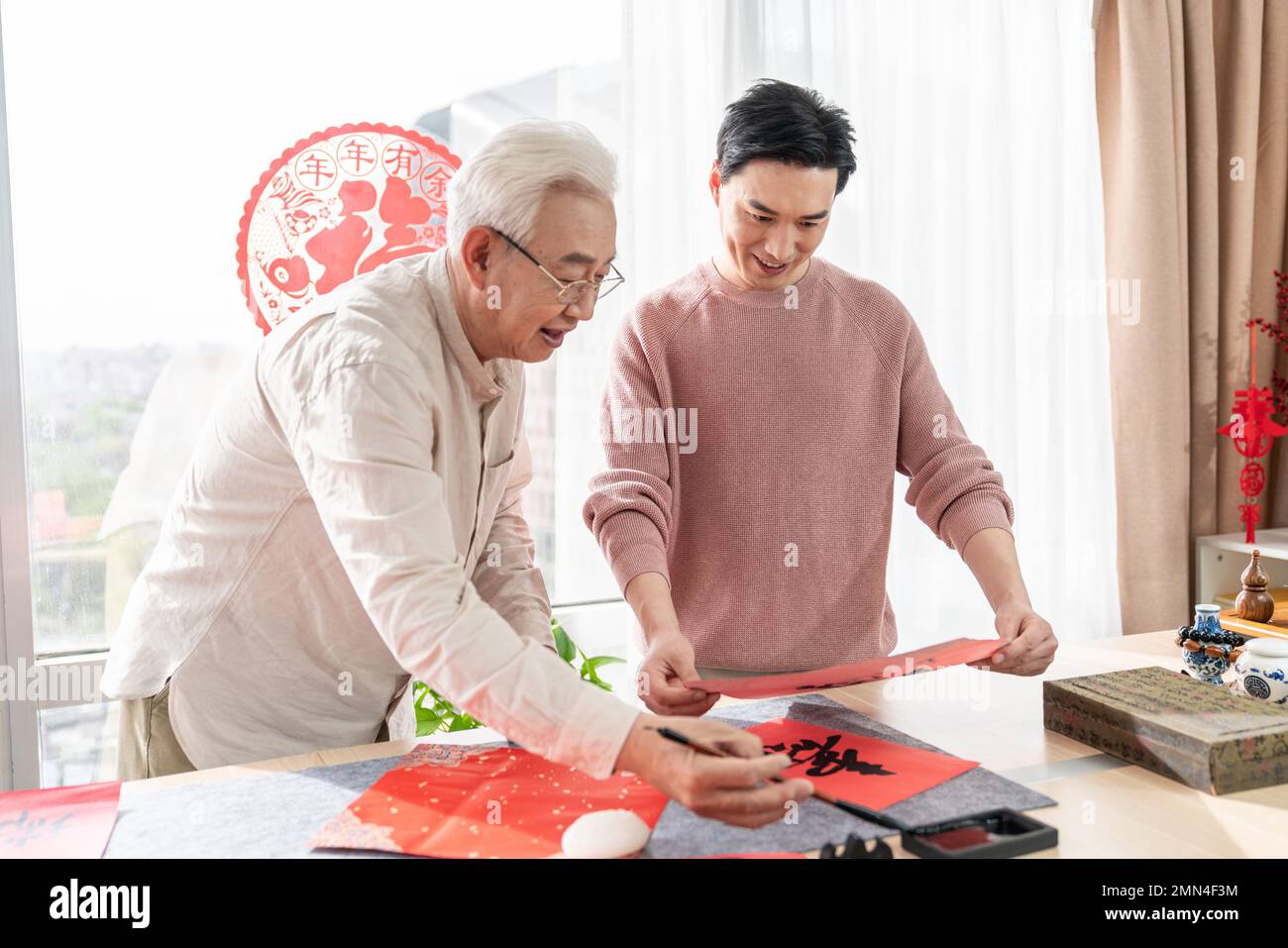 Happy father and son at home to write calligraphy Stock Photo - Alamy